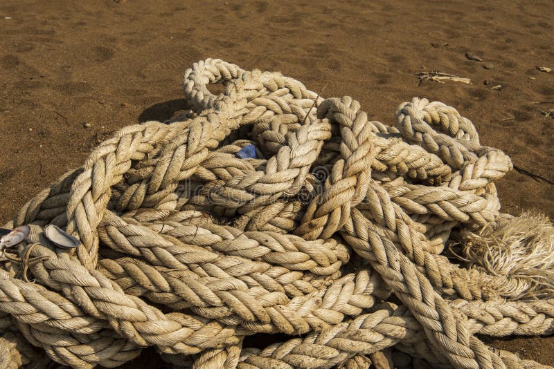 A big rope on the sand stock image. Image of object - 257940869