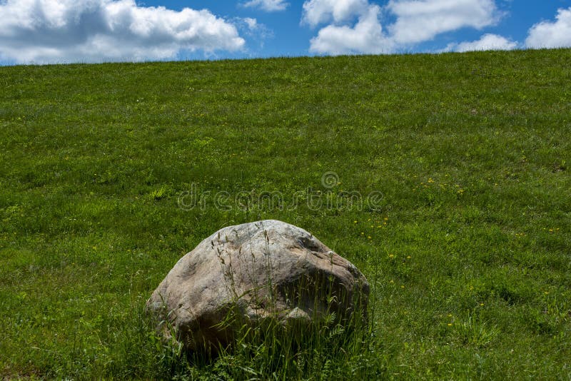 Big Round Stone on Green Grass Stock Image - Image of lawn, field ...