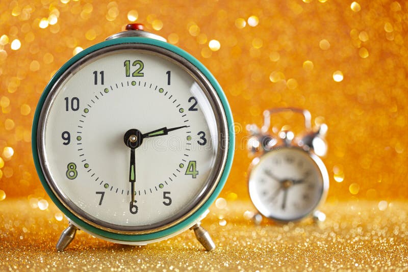 Big and Small Alarm Clock on a Gold Background Stock Image - Image of ...