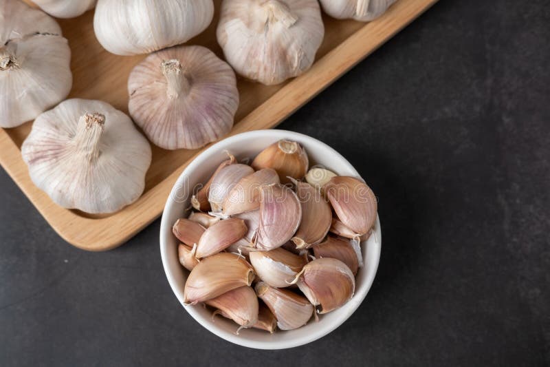 Big and Small Heads of Garlic on a Black Background Stock Image - Image ...