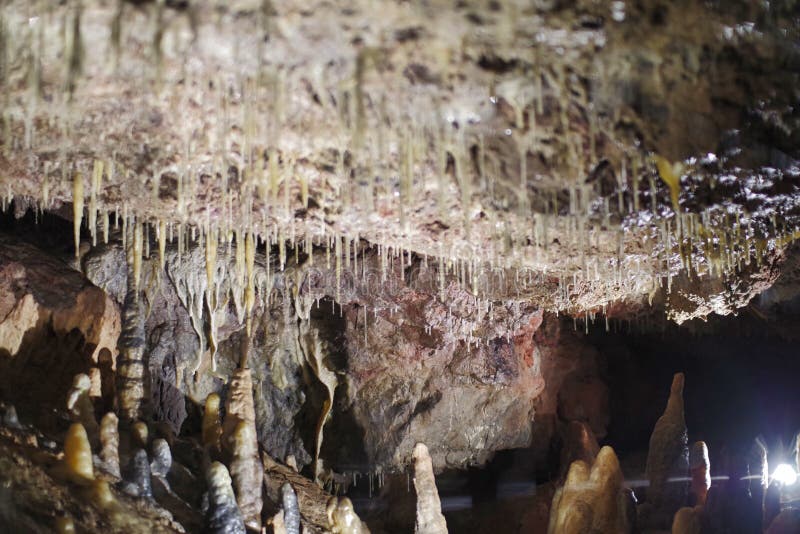 A Big Stalactite is Hanging from the Rock Stock Image - Image of ...