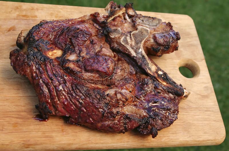 Big steaks on wooden plate stock photo. Image of meat - 7541824