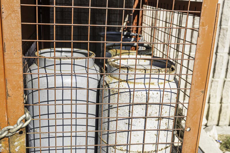 Big Stone Containers on the Other Side of an Orange Fence Stock Image ...