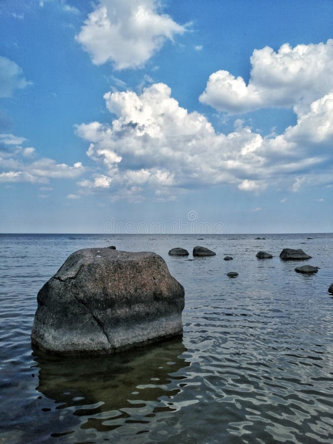 Big stone in sea stock photo. Image of cove, reflection - 229534906
