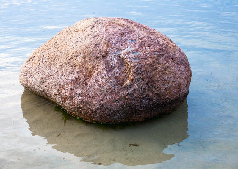 Big stone in shallow water stock image. Image of rock - 263366661