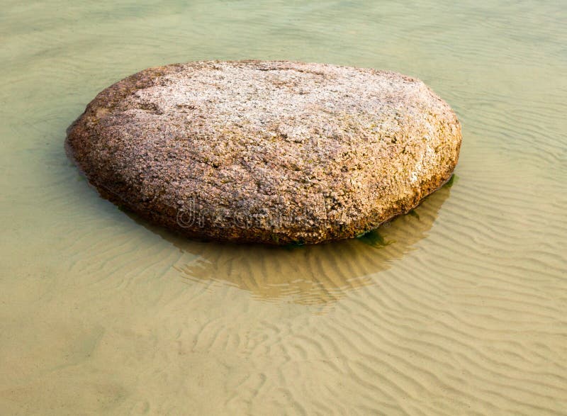 Big stone in shallow water stock image. Image of floor - 264240509