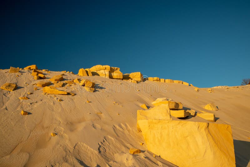 Big Stones in the Desert. Yellow Sand on a Background of Blue Sky ...