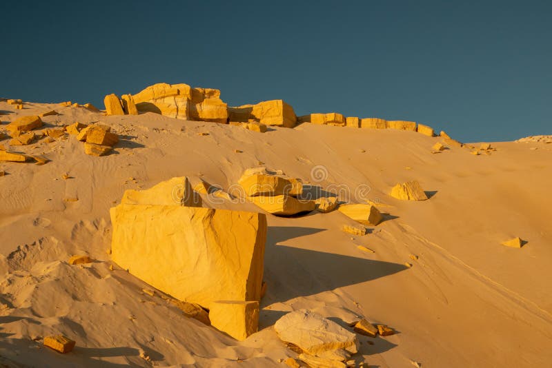 Big Stones in the Desert. Yellow Sand on a Background of Blue Sky ...