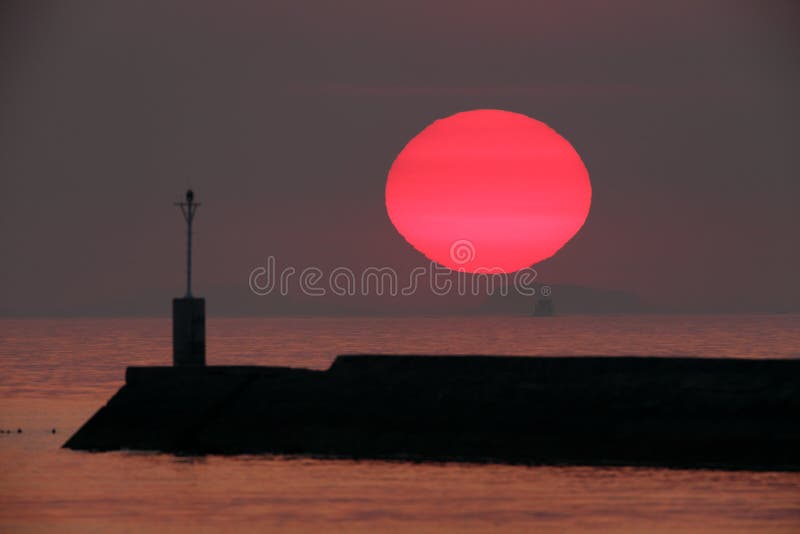 Sunset Over Low Tide Breakwaters Stock Photo - Image of coast, sunrise ...
