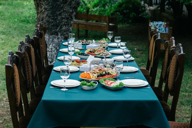 A Big Table Full of Tasty Meals Stock Image - Image of chairs, family ...
