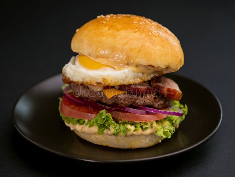 Big Tasty Burger with Beef Cutlet, Lettuce, Egg and Cheese on a Black ...