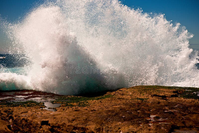 Big wave breaking on rocks stock photo. Image of nature - 31298942