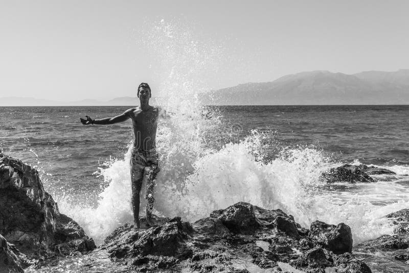 Big Wave Splash on the Man Standing on the Beach Stock Photo - Image of ...