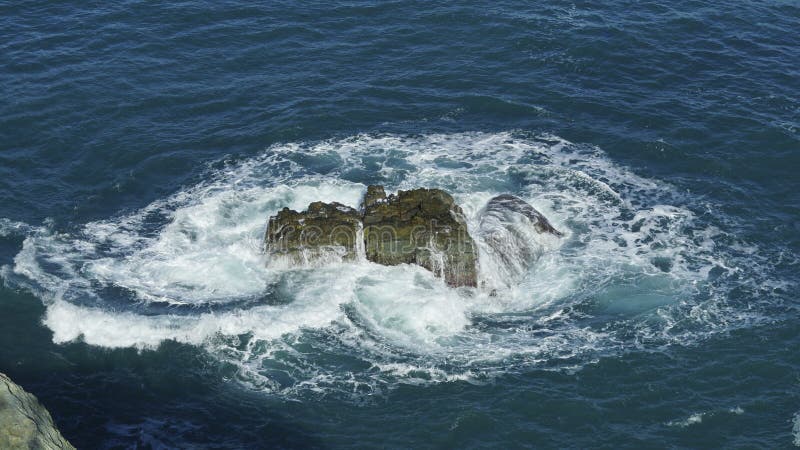Big Waves Hitting the Rock in the Middle of the Ocean Stock Photo ...
