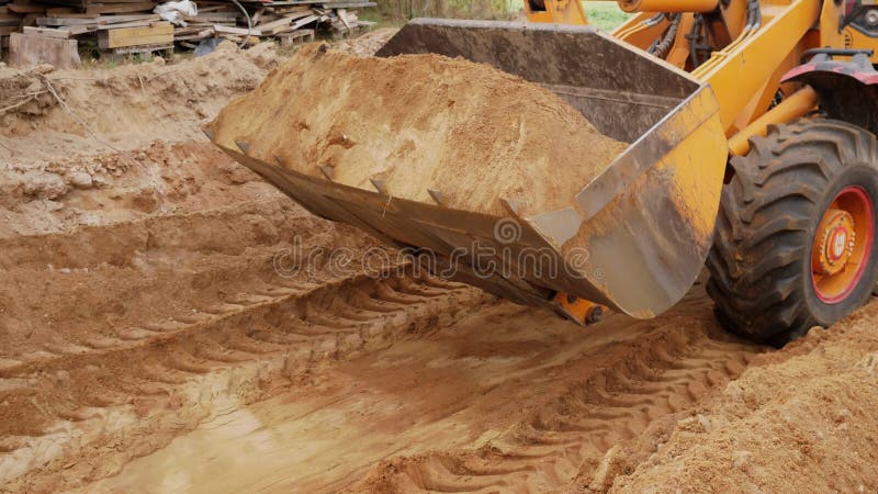 A Big Wheel Loader and a Full Bucket of Sand Stock Video - Video of ...