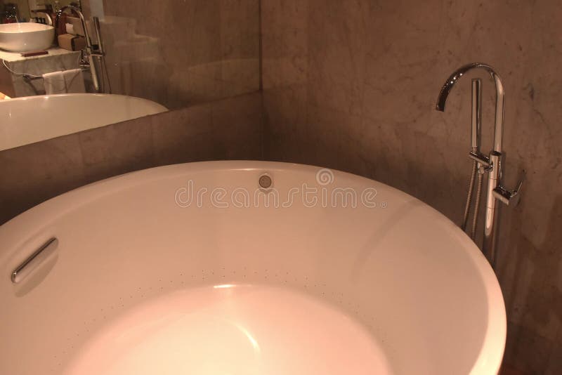 Big White Bathtub and Reflection on Mirror in Bathroom Stock Image ...