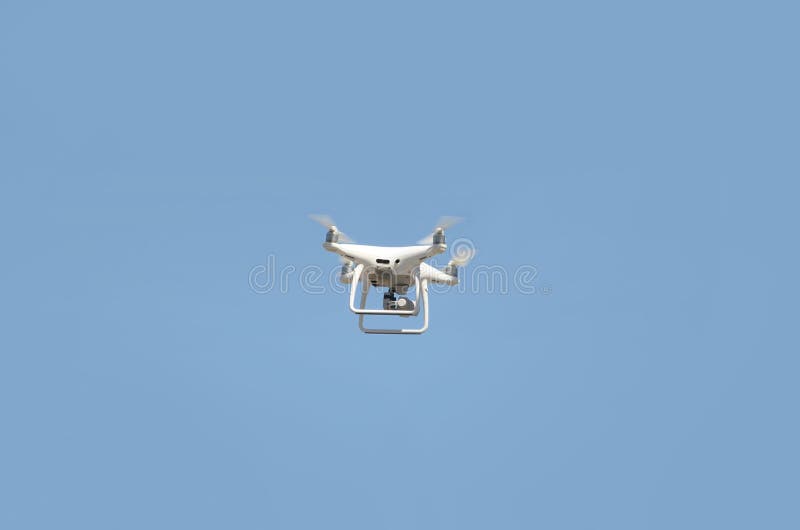 Big White Drone Hovering in a Bright Cloudless Blue Sky Stock Photo ...