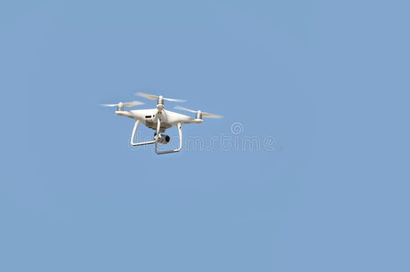 Big White Drone Hovering in a Bright Cloudless Blue Sky Stock Image ...