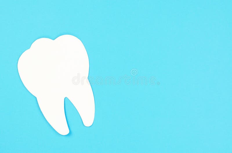 Big White Tooth on a Blue Background. Dental Care Concept Stock Photo ...
