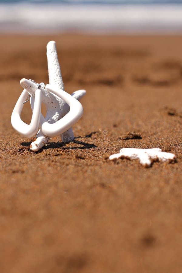 Big White Trendy Earrings on Sand, Summer Beach Accessories Stock Image ...