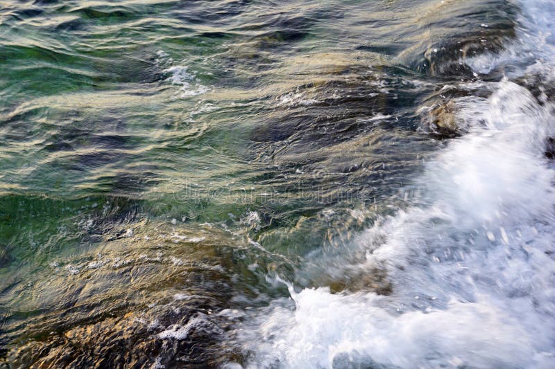 White Wave and Sea Foam on Top of Rocks Under Turquoise Sea Water Stock ...