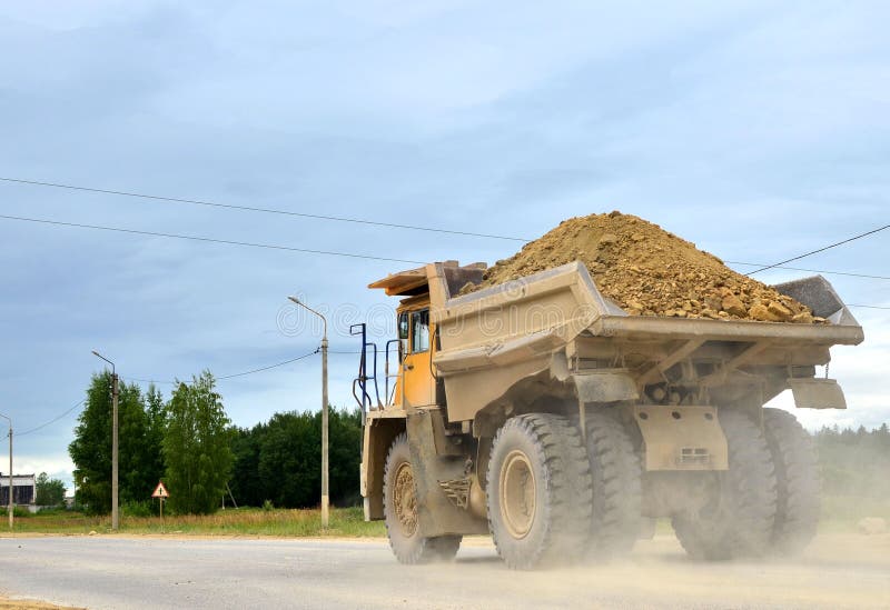 Big Yellow Dump Truck Working in the Limestone Open-pit. Loading and ...