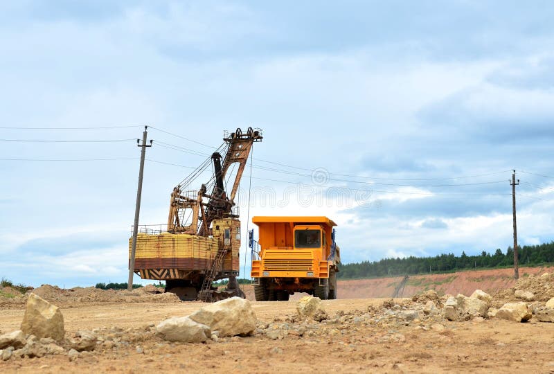 Big Yellow Dump Truck Working in the Limestone Open-pit. Loading and ...