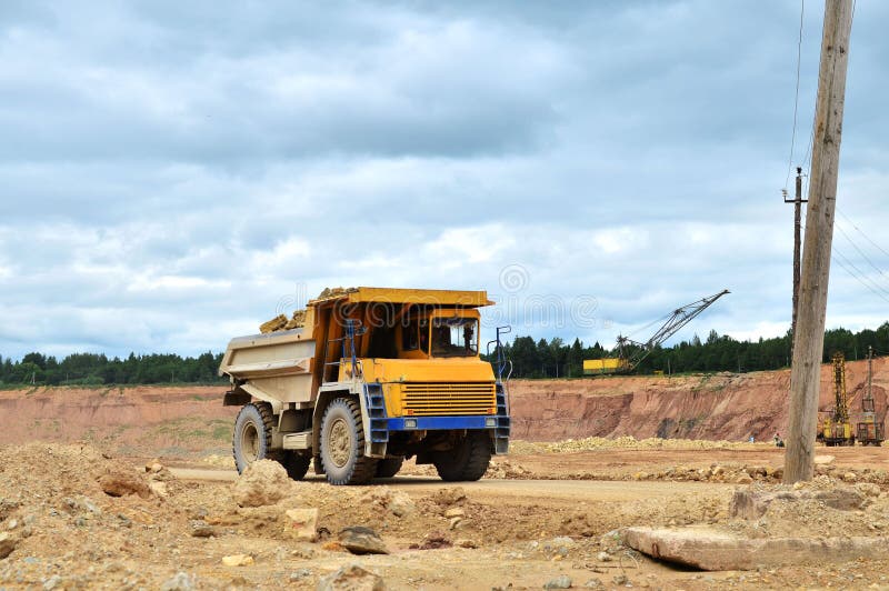 Big Yellow Dump Truck Working in the Limestone Open-pit. Loading and ...