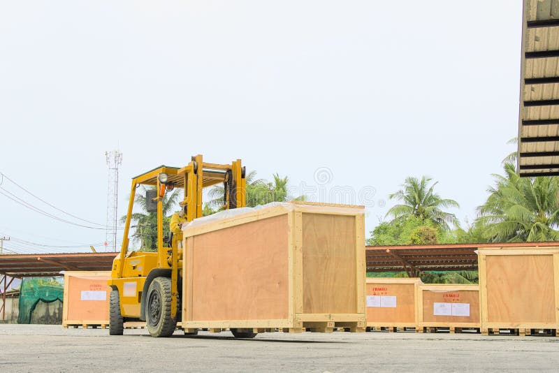 Big Yellow Forklift Lifting a Wooden Box Stock Photo - Image of machine ...