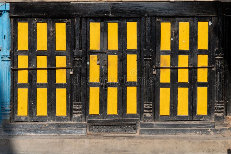 Large Metal Yellow Doors with Black Frames on the Side of a Building ...