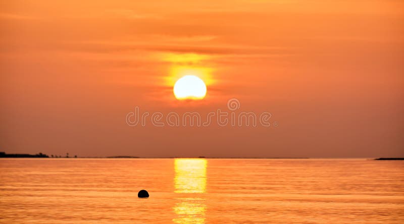 Big Yellow Sun Setting Down Over Sea Surface Stock Photo - Image of ...
