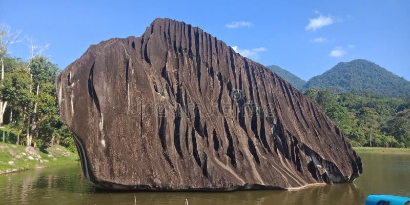 Big Black Rock in the Middle of the Lake Stock Photo - Image of black ...
