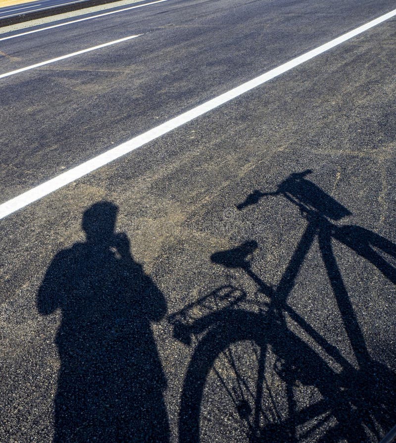 Bike and Human Shadow, Bike and on Asphalt Road Stock Image - Image of ...
