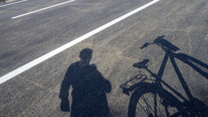 Bike and Human Shadow, Bike and on Asphalt Road Stock Image - Image of ...