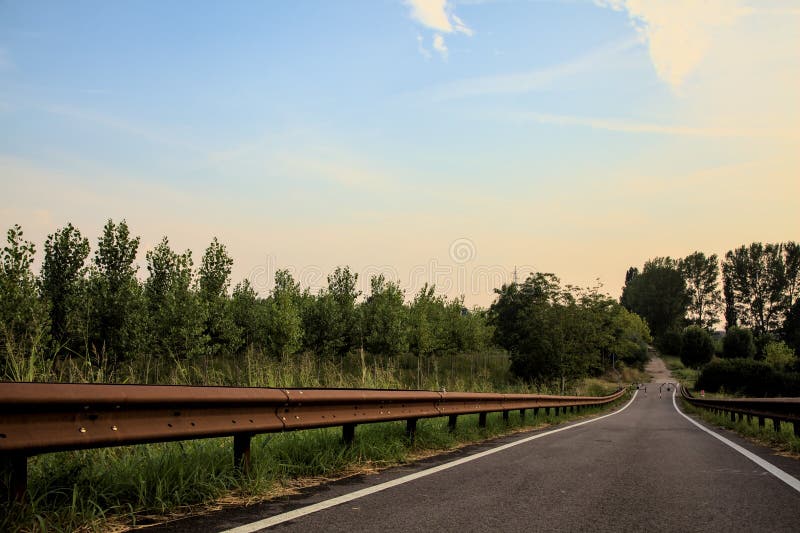 Bike Path in the Countryside with a Cloudy Sky at Sunset in Summer ...