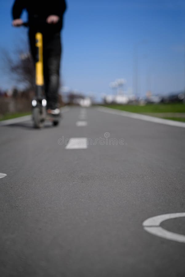 A Bike Path and a Man on an Electric Scooter. Bottom View of the Bike ...