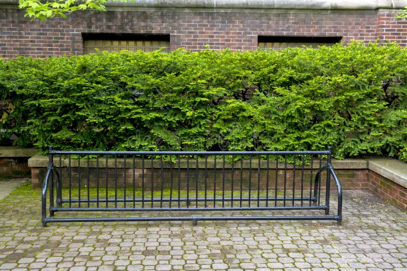Bike Rack and Bush Against Building Stock Photo - Image of rack, green ...
