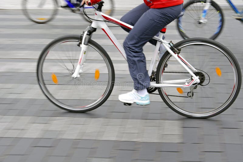 Bike riders on the street stock image. Image of side - 26902945