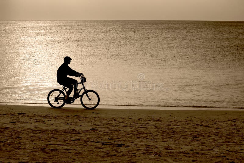 Bike riding on the beach stock image. Image of sand, bike - 25540743