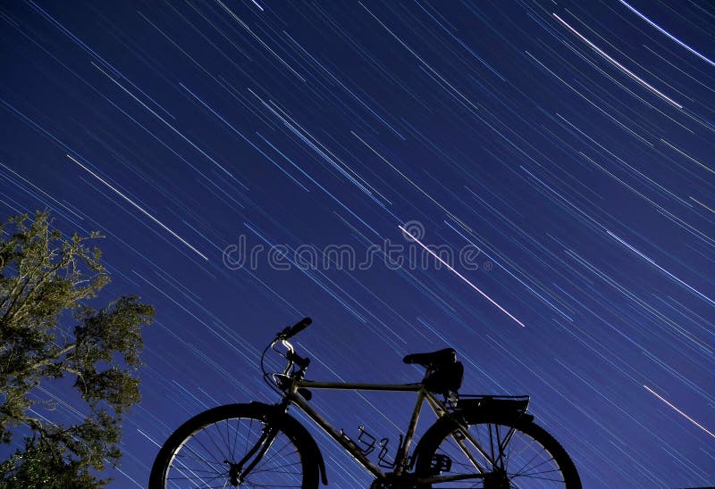 Bike and tree under stars stock image. Image of astrophotography - 65318419