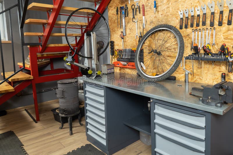 Bike Workshop with Metal Workbench Holding Bicycle Wheel Tools Hanging Stock Photo - Image of ...