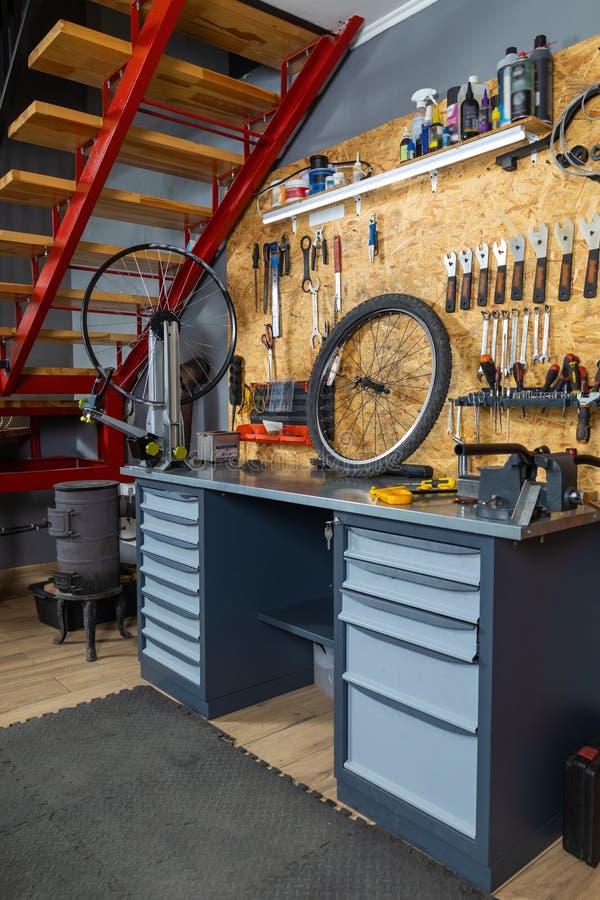 Bike Workshop with Metal Workbench Holding Bicycle Wheel Tools Hanging ...