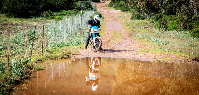 Biker on an Adventure Bike by a Puddle Stock Photo - Image of bike ...