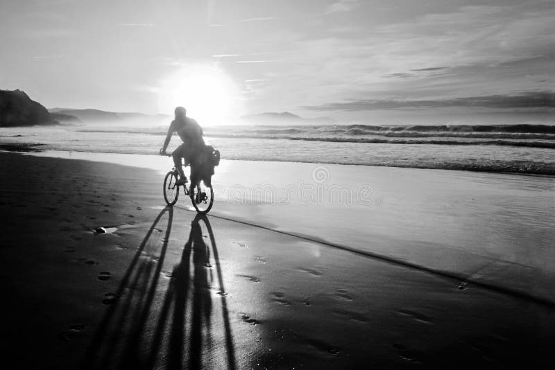 Biker Biking on Beach at Sunset with Bicycle Shadow Stock Image - Image ...