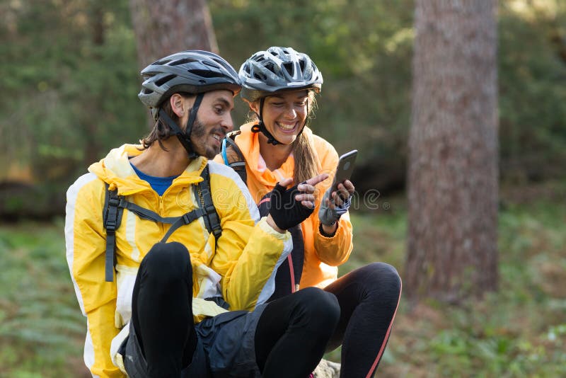 Biker Couple Using Mobile Phone Stock Photo - Image of healthy ...