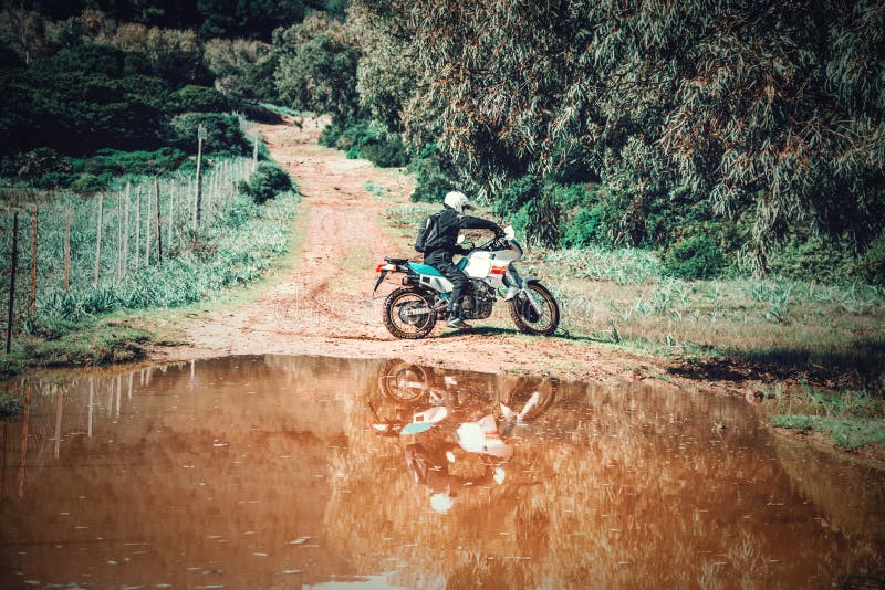 Biker and His Adventure Bike Reflected in a Puddle Stock Photo - Image ...