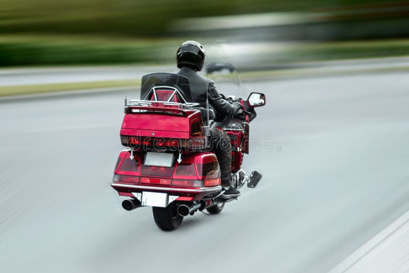 Biker in Motion on the Highway, Rides on the Road, Rear View on a Red ...