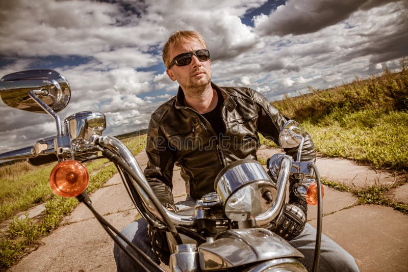 Biker on a motorcycle stock image. Image of autumn, jeans - 124613629