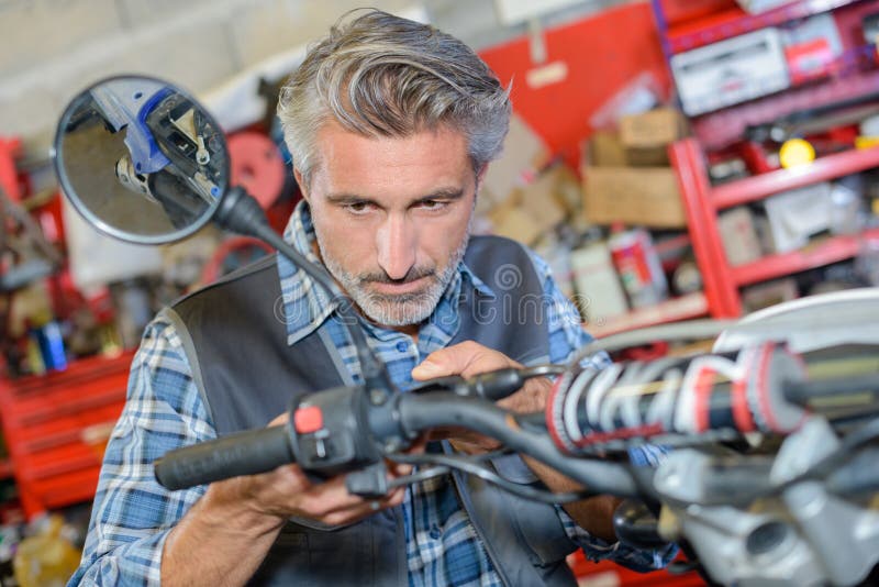 Biker polishing spare part stock photo. Image of sporty - 116222486