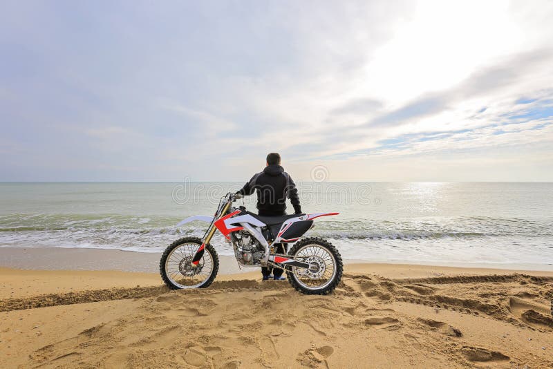 Biker Sitting on a Motorcycle on the Beach Stock Photo - Image of sand ...